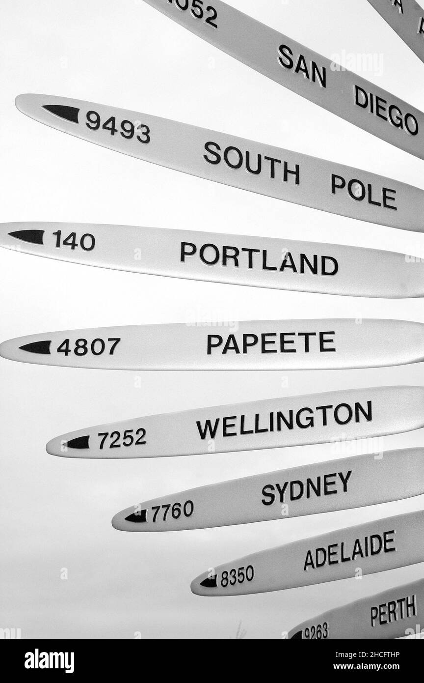 Closeup of a direction sign with names of cities and distances on a ...