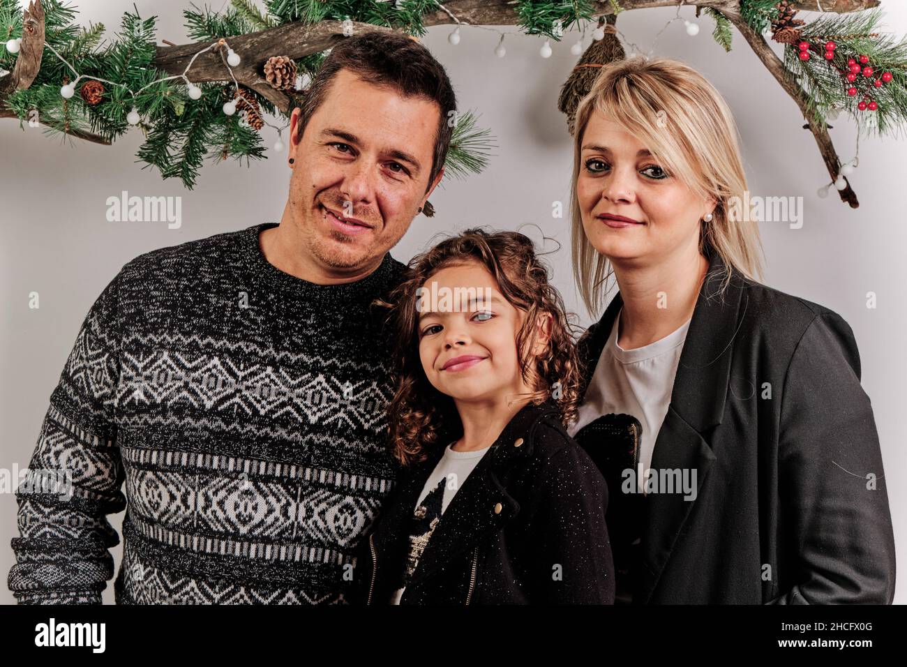 Adorable Spanish family having a groupie during a Christmas event Stock ...