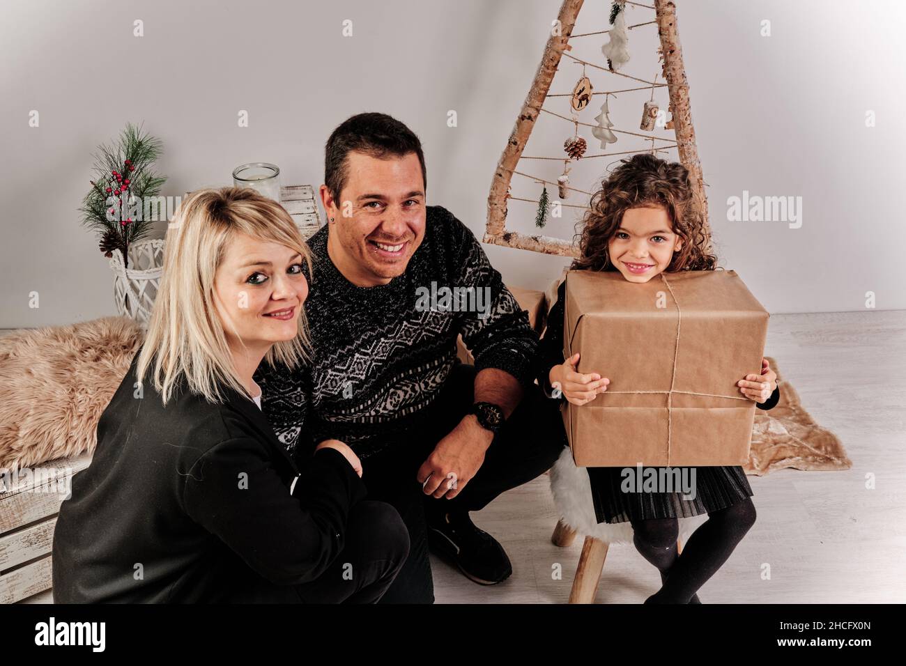 Adorable Spanish family having a groupie during a Christmas event Stock ...