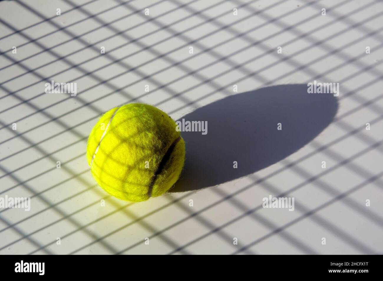 Tennis ball and shadows on isolated white background Stock Photo - Alamy