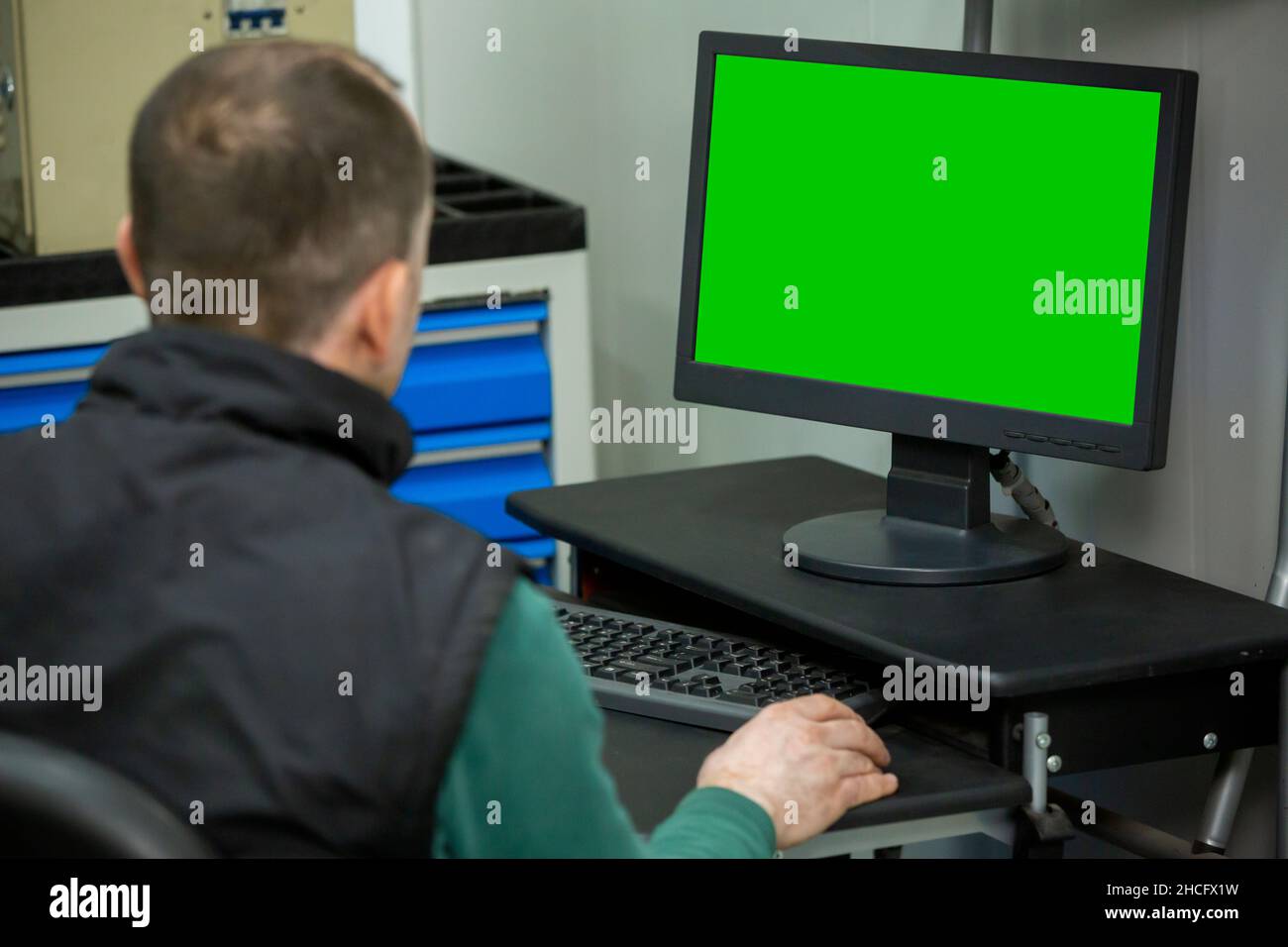 Back view worker working at computer Stock Photo - Alamy