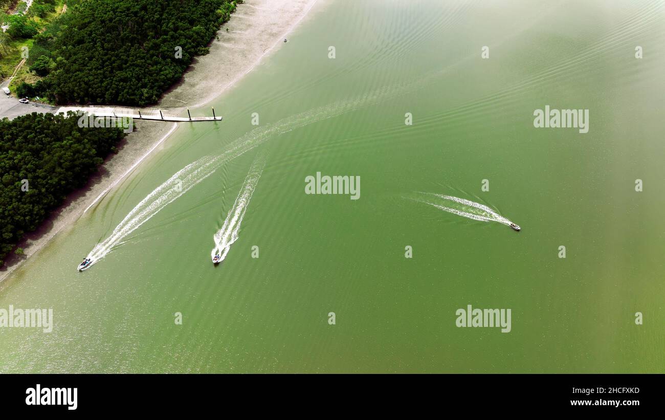 Three power boats leaving from Conway Beach boat ramp and jetty on ...