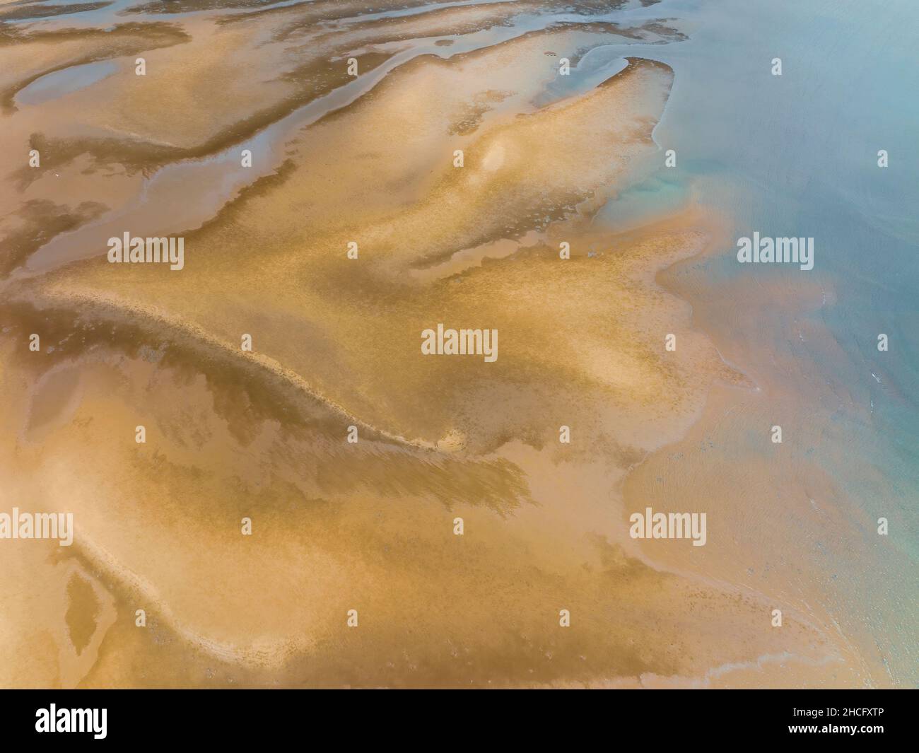 Patterns in the sand of the ocean bed at low tide on a beach, drone ...