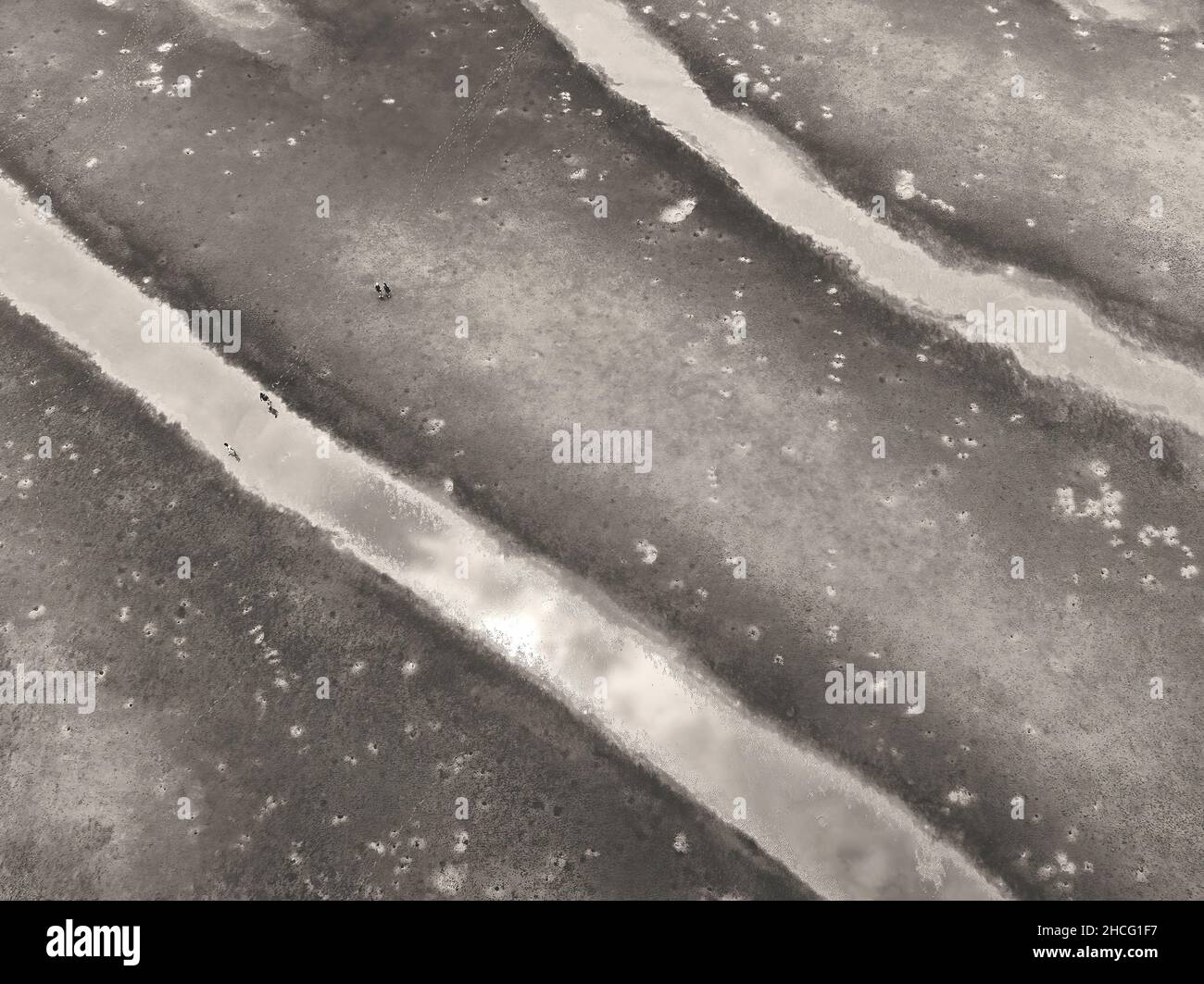 Patterns in the sand of the ocean bed at low tide on a beach, drone ...