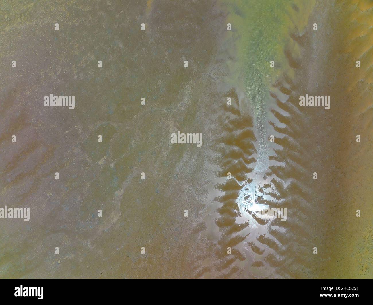 Patterns in the sand of the ocean bed at low tide on a beach, drone ...