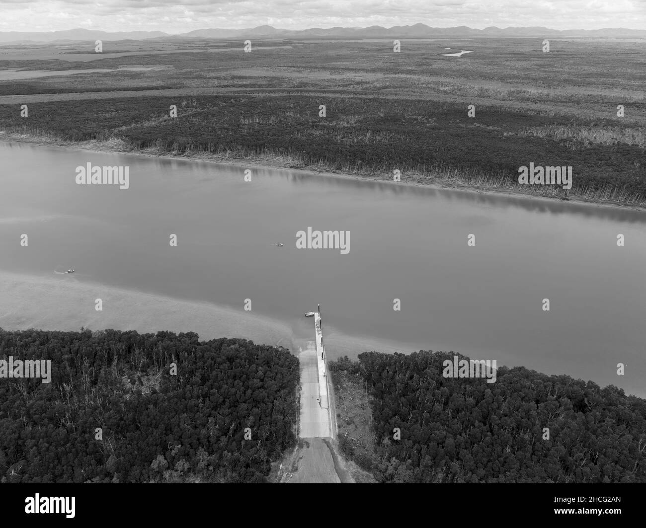 Overhead drone view of boat launch ramp and jetty rendered in black and ...