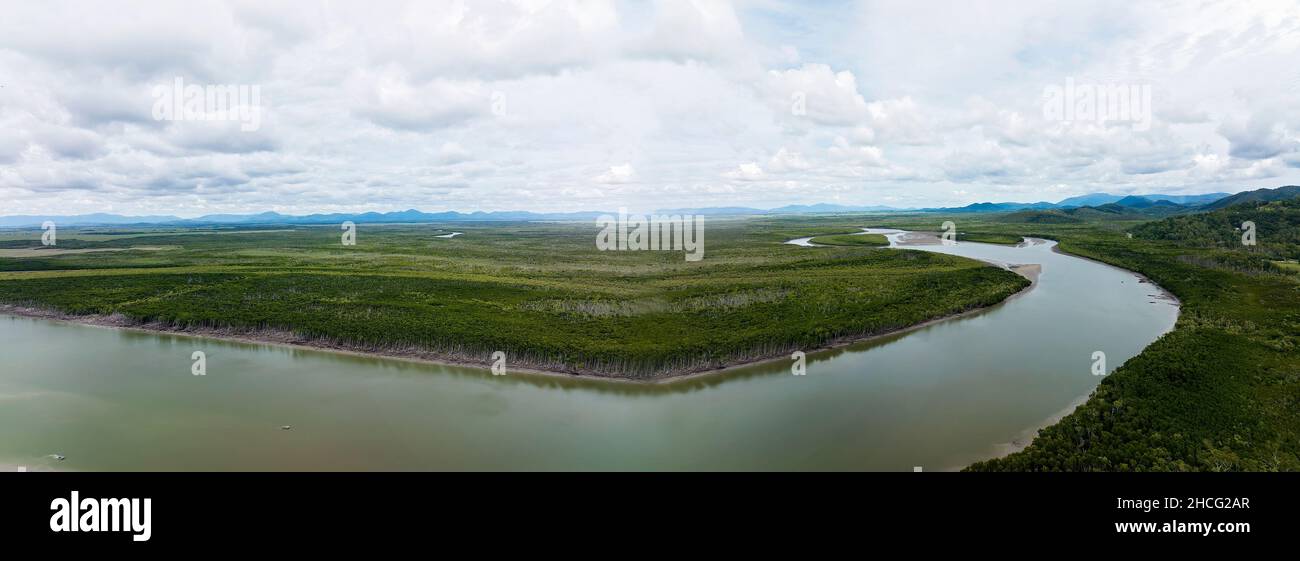 Panorama of a tidal river with sand bars showing and the banks lined ...