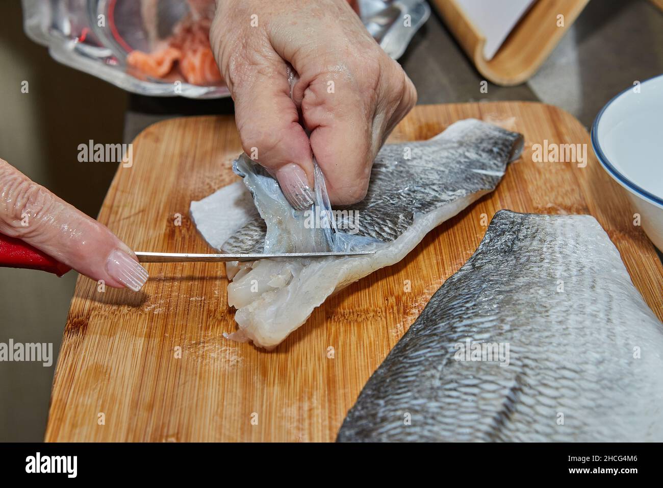Chef is skinning salmon fillets for cooking Stock Photo - Alamy