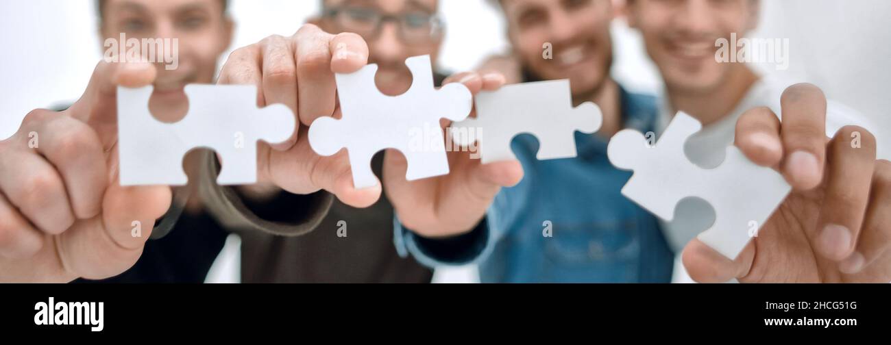group of young people with puzzle pieces Stock Photo - Alamy