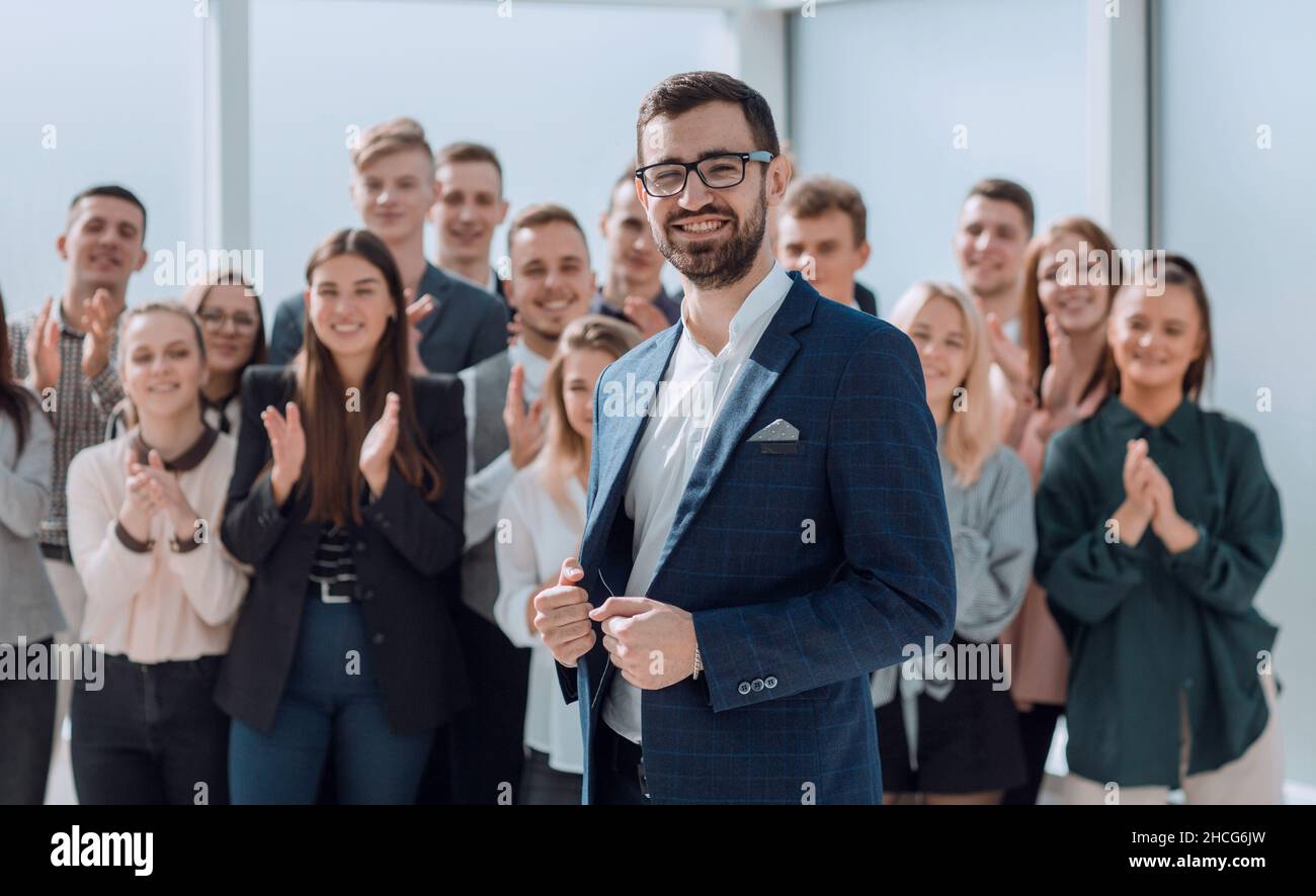 Manager and a group of diverse employees standing in the new office ...