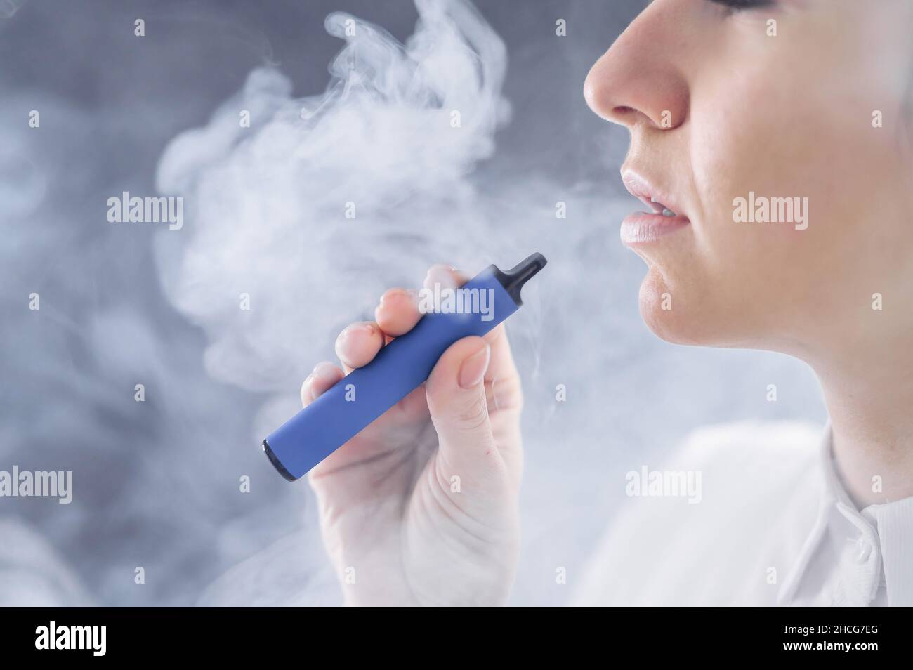 Caucasian woman smokes disposable vape hi-res stock photography and ...