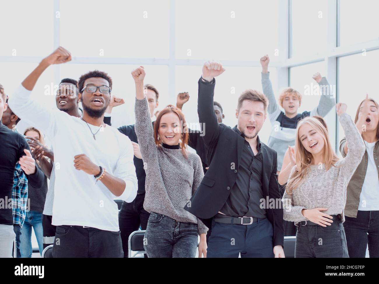group of happy young people standing with their hands up Stock Photo ...
