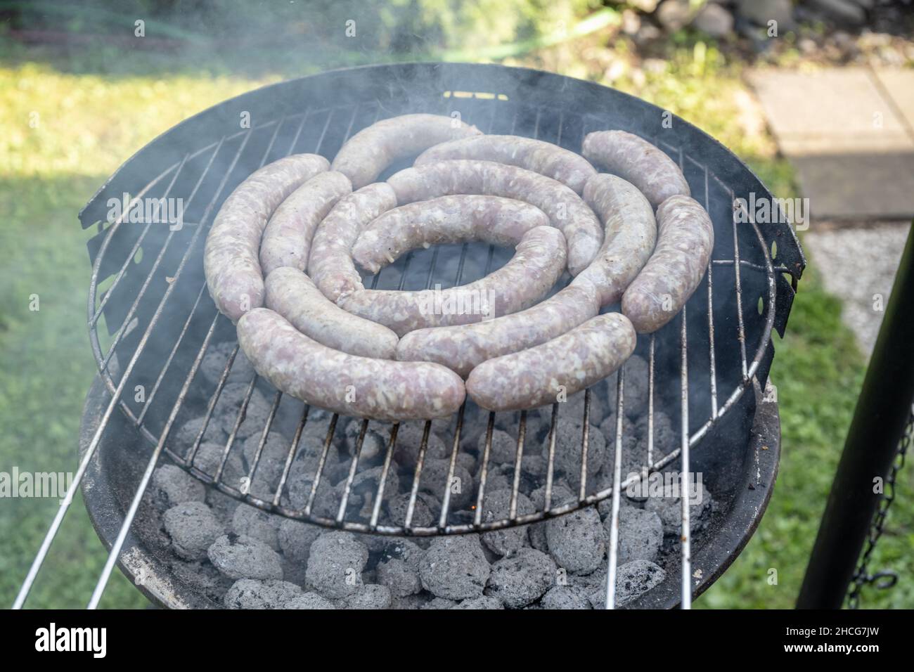 Barbecue Grill Bbq On Coal Charcoal Grill With Raw Bratwurst Sausages