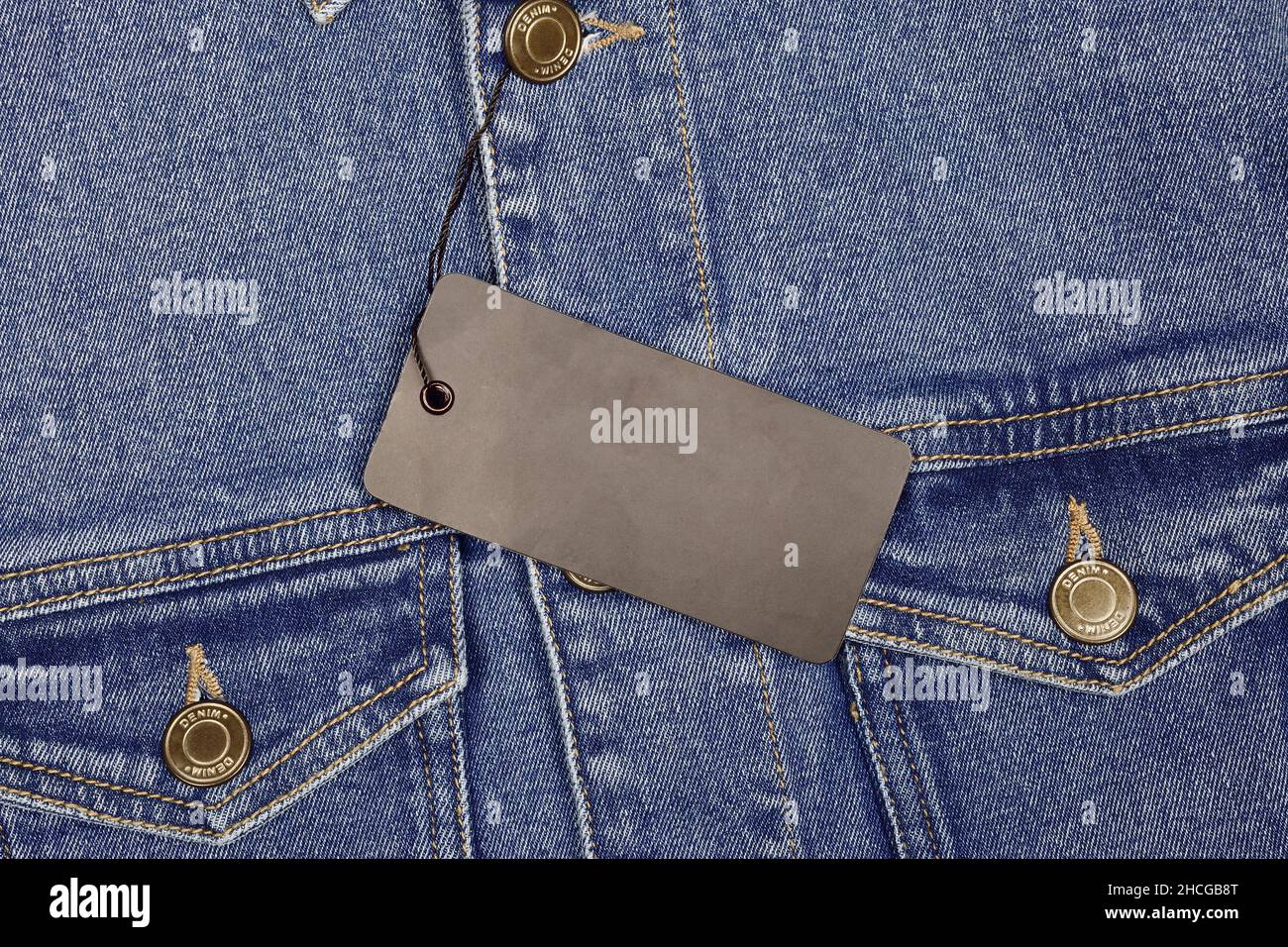 Blank Price Tag on Denim Jacket Stock Photo - Alamy