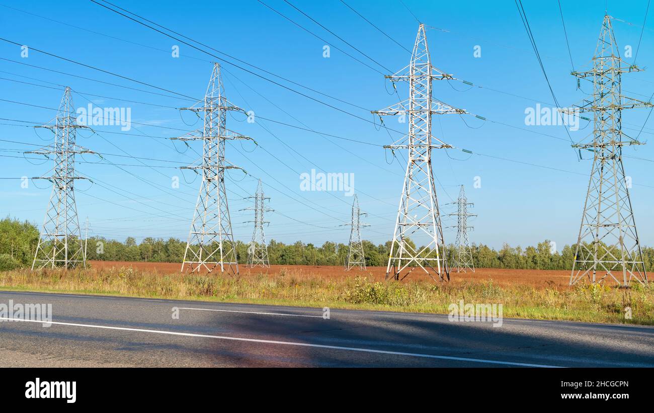 High-voltage power lines and power pylons near the highway ...