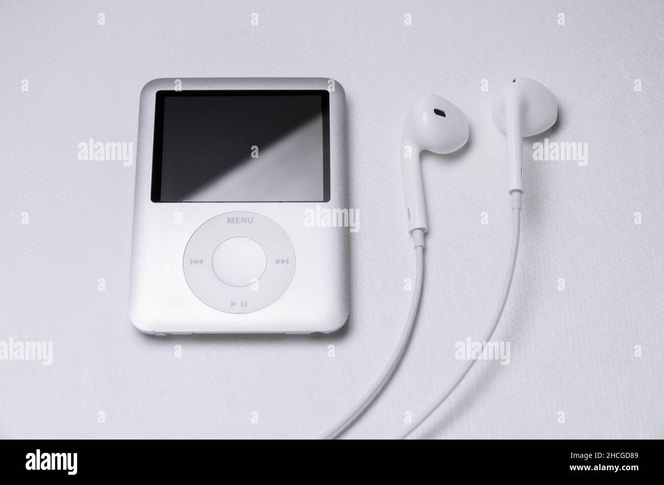 Close-up of Apple iPod nano 3rd Generation with EarPods on white ...