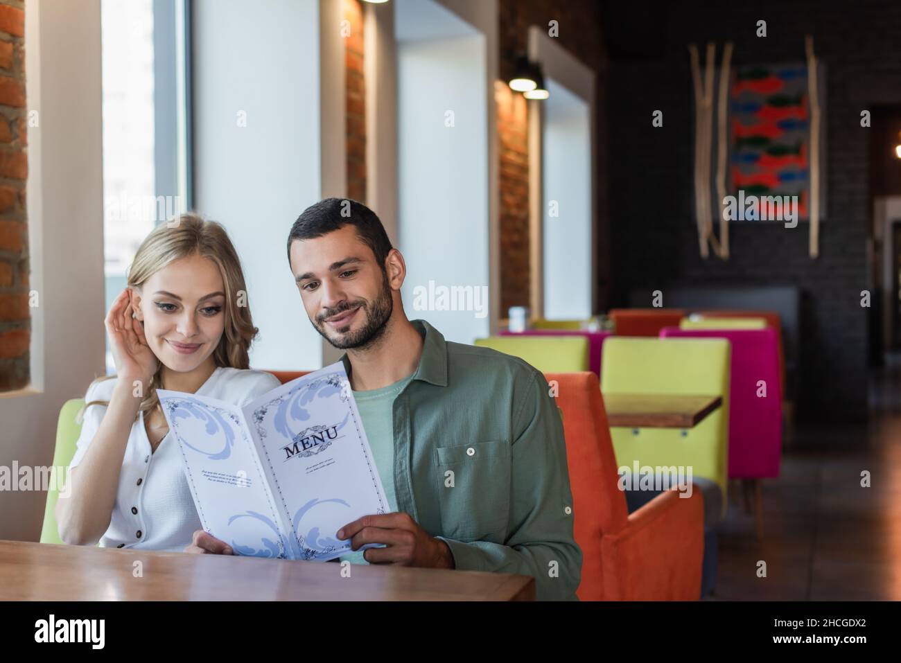 Beautiful couple choosing from menu hi-res stock photography and images ...