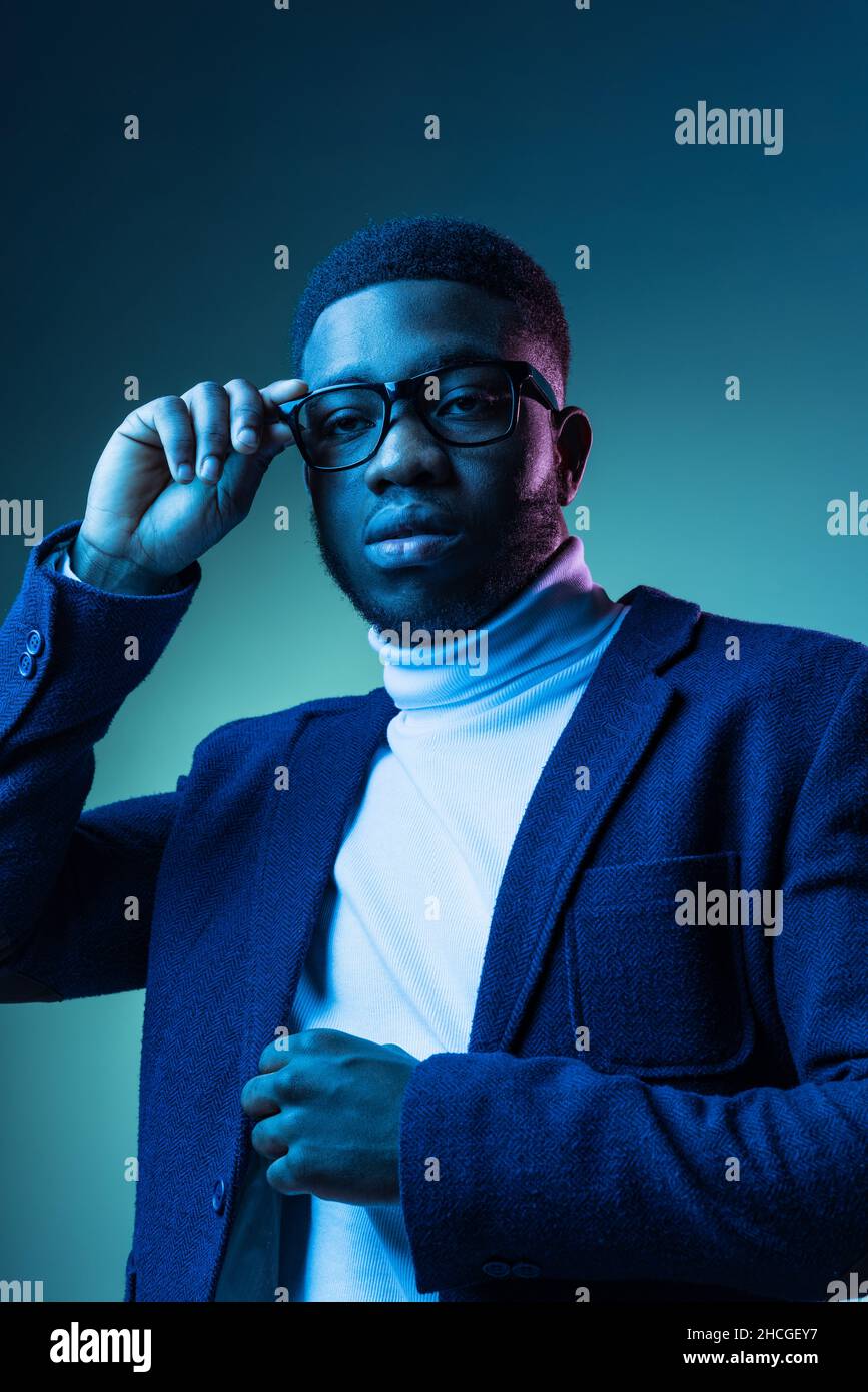 Half-length portrait of young stylish african man, student wearing ...