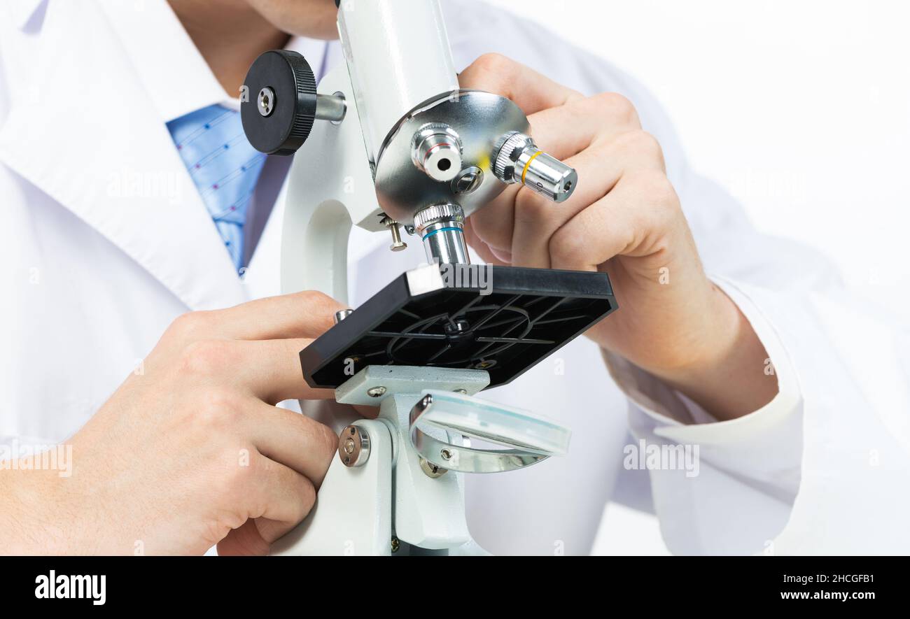 Scientist looking through microscope in laboratory Stock Photo - Alamy