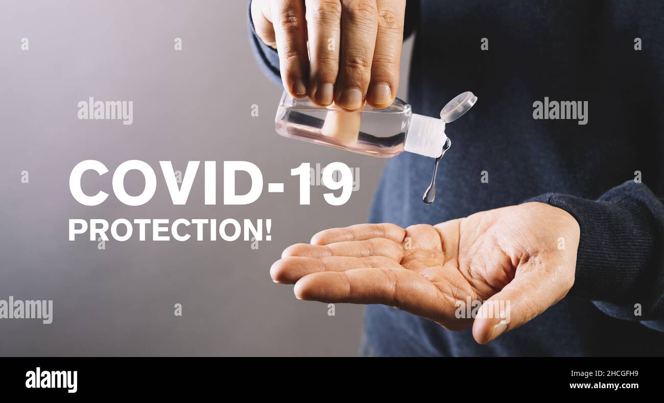 Pouring disinfection gel on hands as COVID-19 Protection. Hand ...
