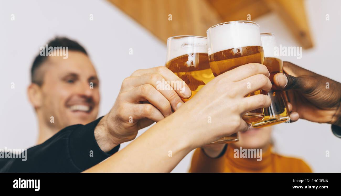 Group Of Friends Enjoying Beer Glasses In Brewery English Pub Young