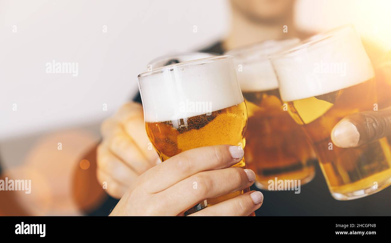 Group of friends enjoying a beer Stock Photo - Alamy