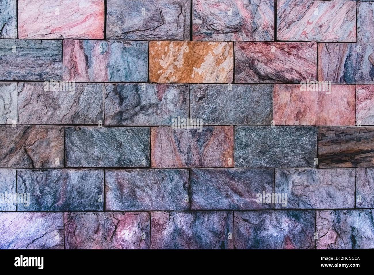 Decorative wall cladding with multi-colored granite tiles. Background ...