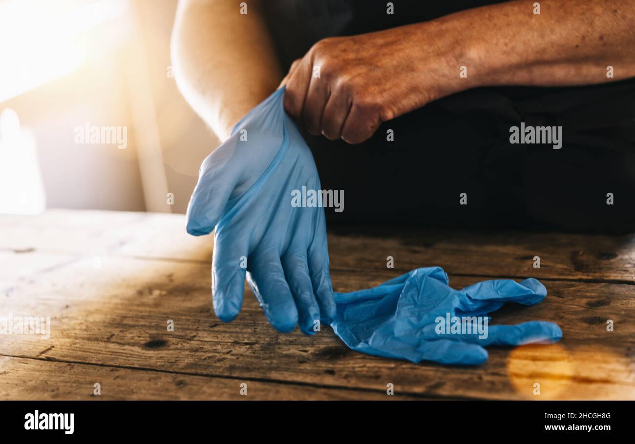 bartender or employee wearing a medical Latex gloves at work to prevent ...