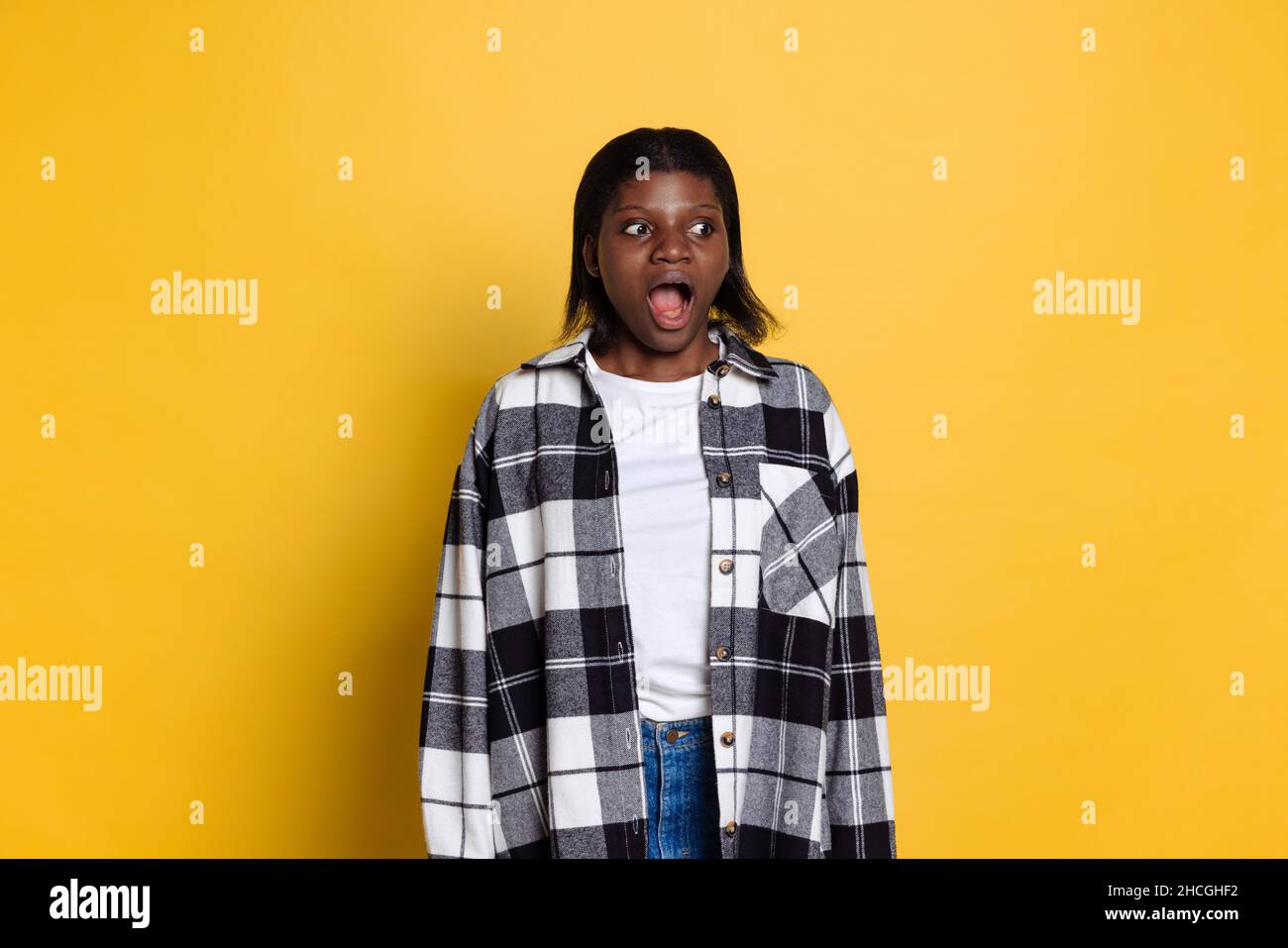 Shocked Young Beautiful Dark Skinned Girl Standing With Open Mouth