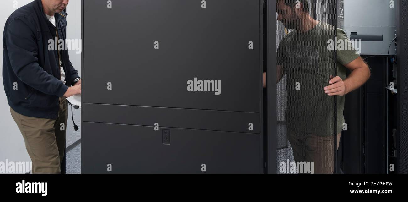 Technicians team updating hardware inspecting system performance in ...