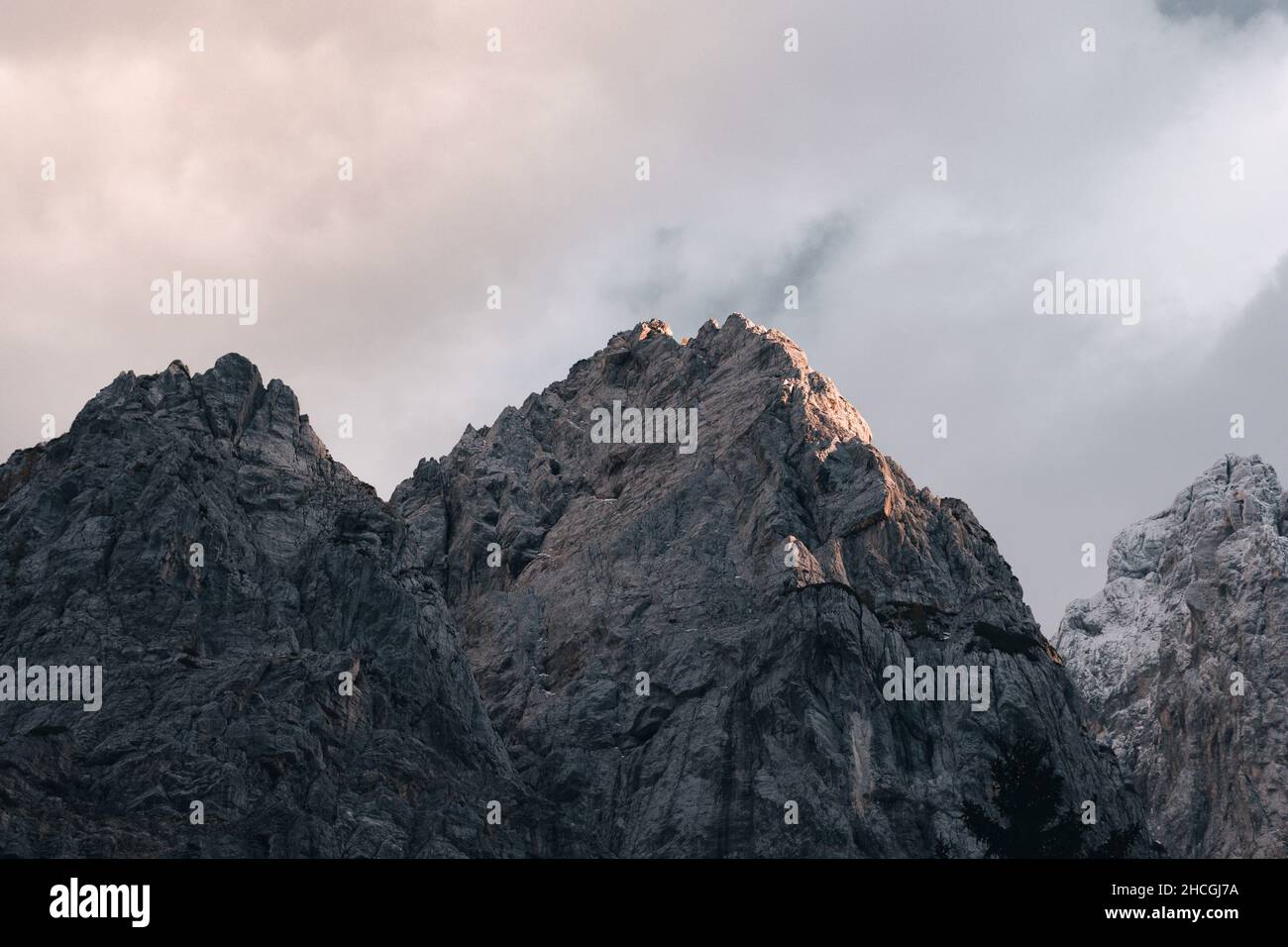 Closeup of the peak of a mountain chain covered with rays of the sun ...
