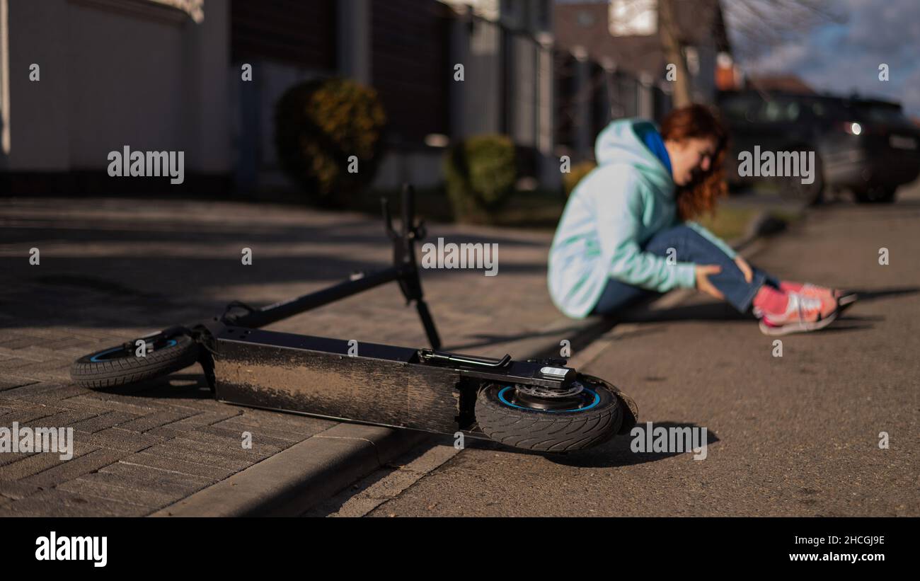A Caucasian woman fell from an electric scooter and injured her leg ...