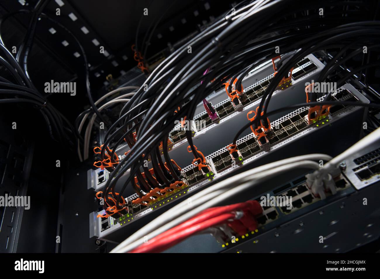 network server room closeup on fiber optic hub or switch for digital ...