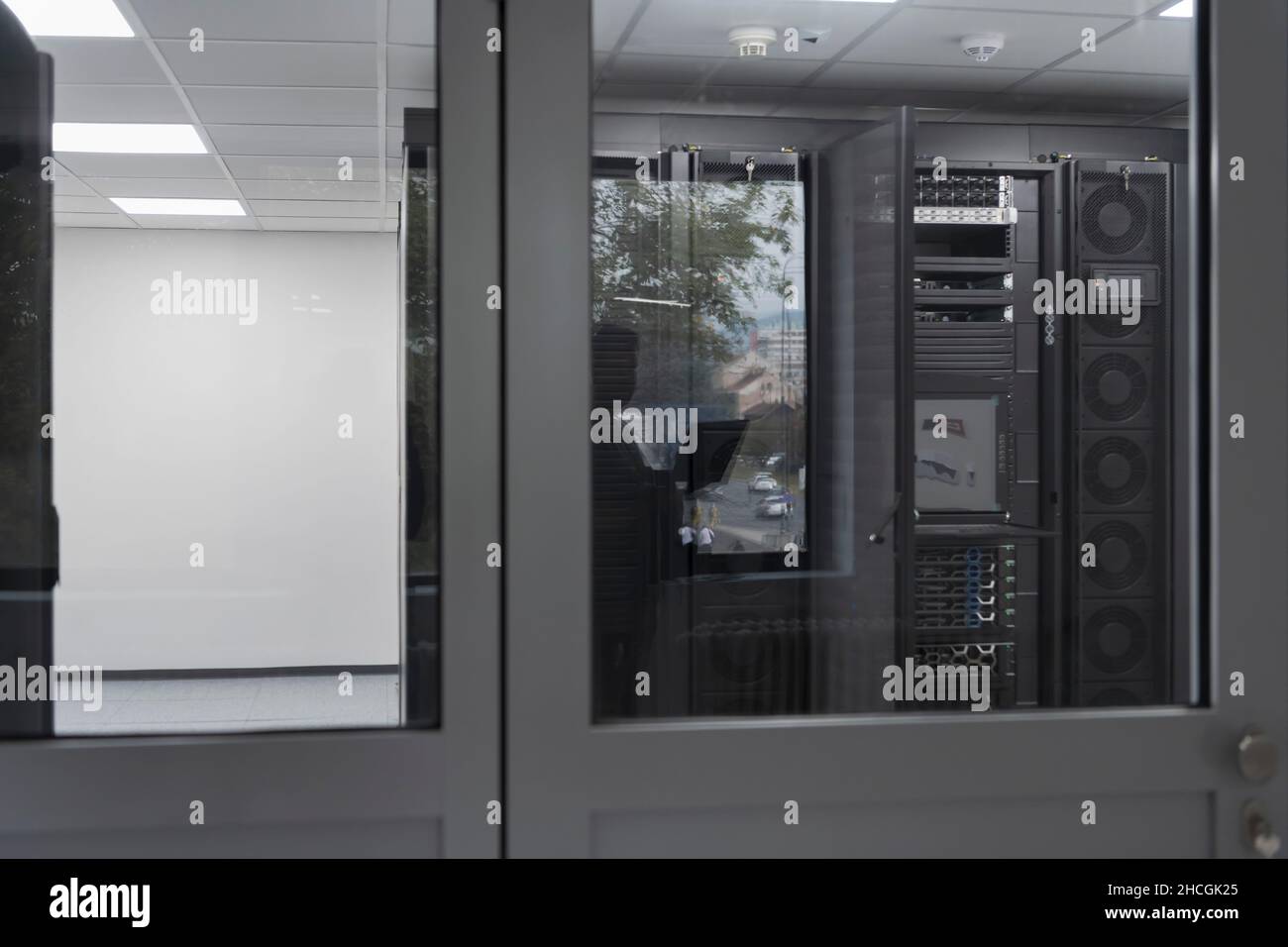 Software Engineer Working on a Laptop Computer in a Modern Server room ...