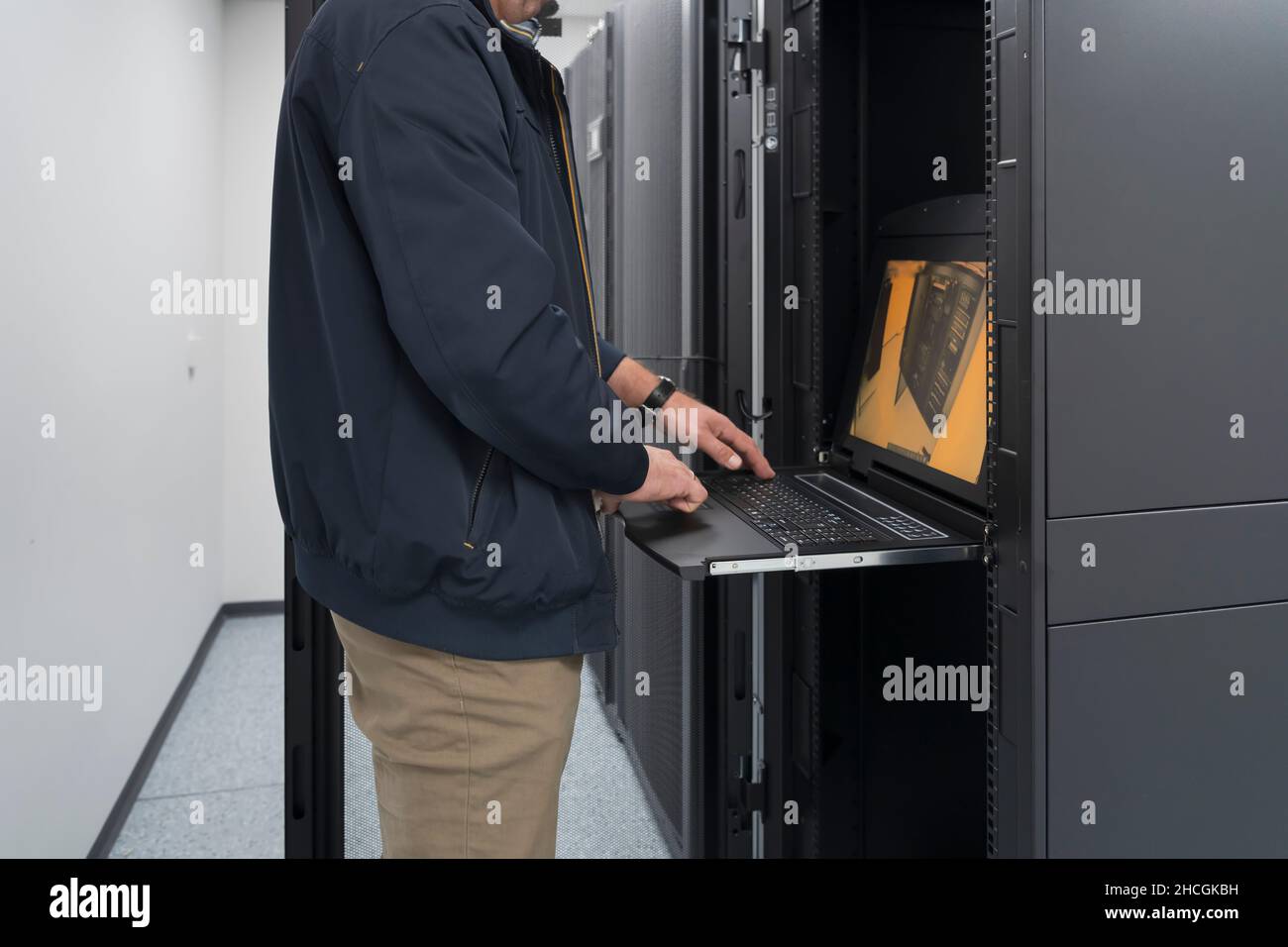 Close up on Data Center Engineer hands Using keyboard on a ...