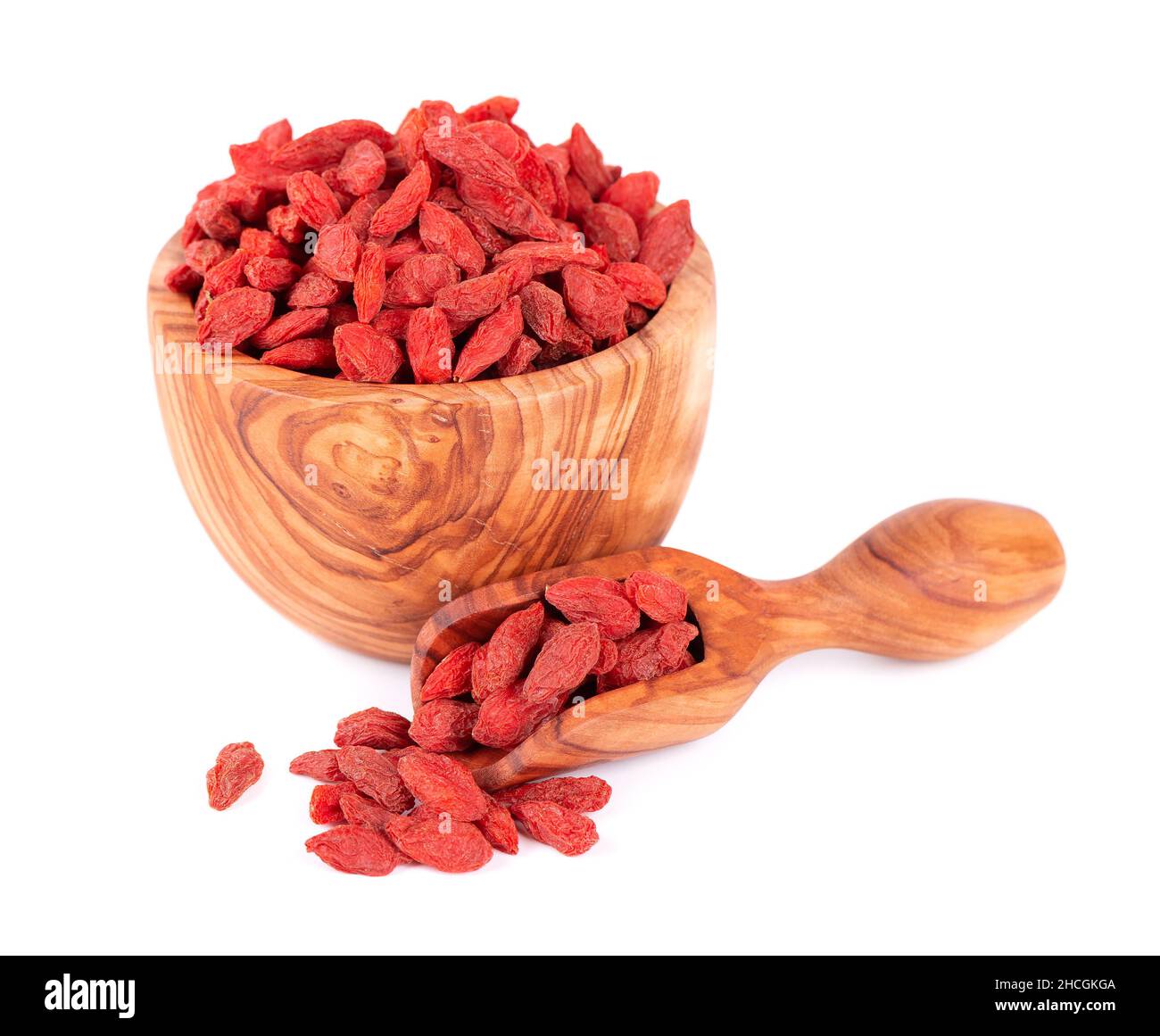 Chinese wolfberries in olive bowl and scoop, isolated on white ...