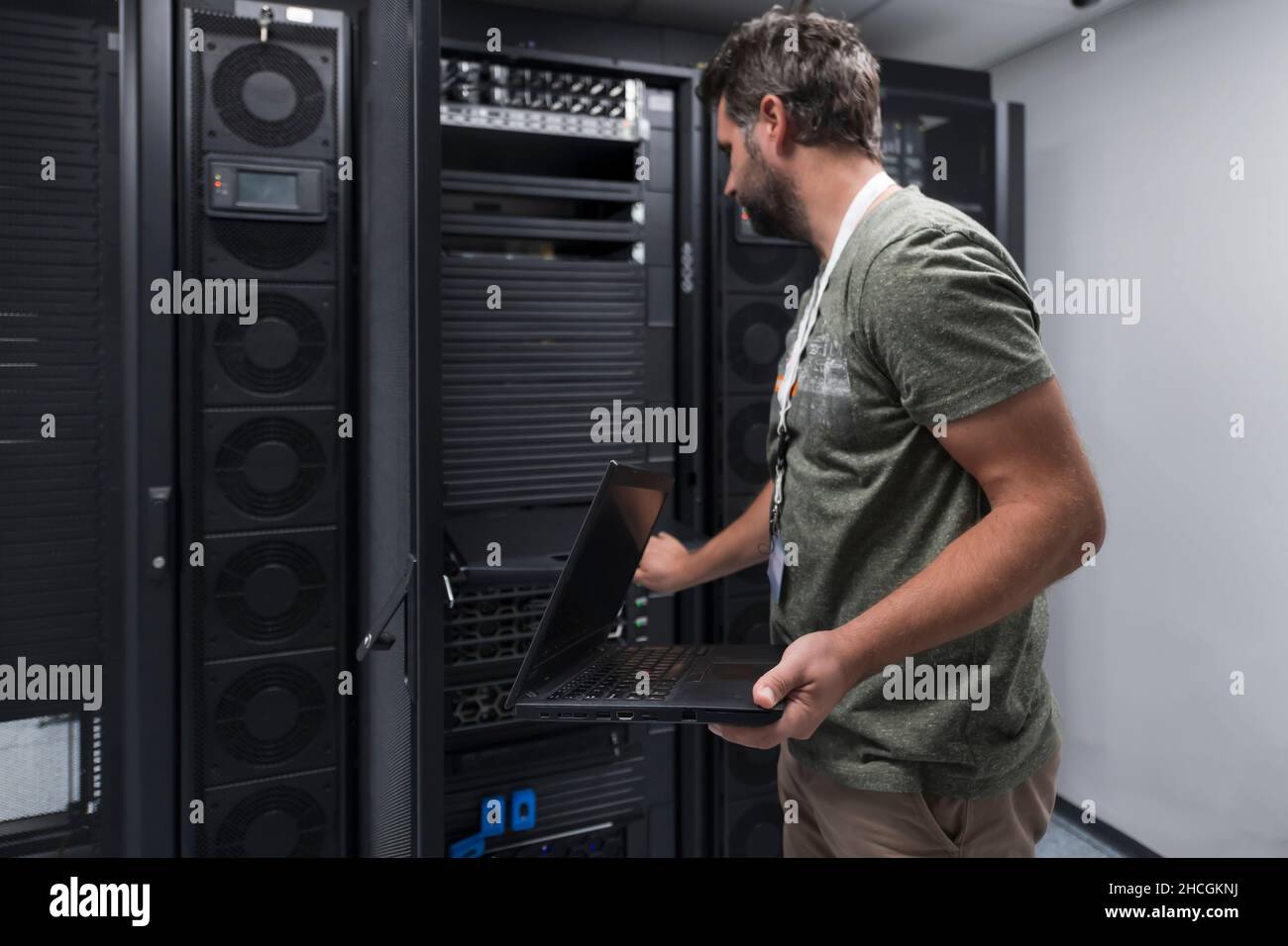 Data Center Engineer Usaing Keyboard on a Supercomputer Server Room ...