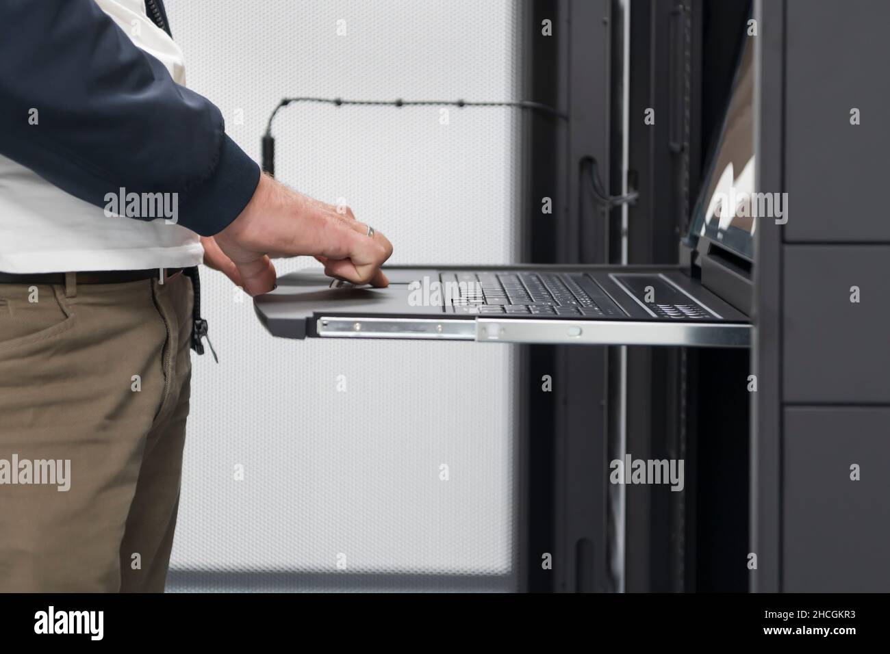 Close up on Data Center Engineer hands Using keyboard on a ...