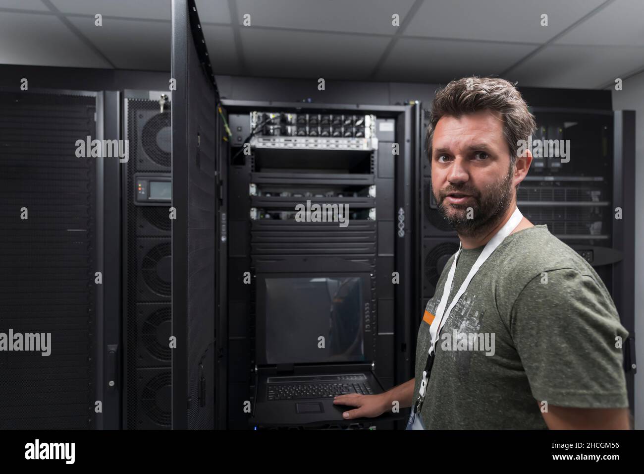 Data Center Engineer Usaing Keyboard on a Supercomputer Server Room ...