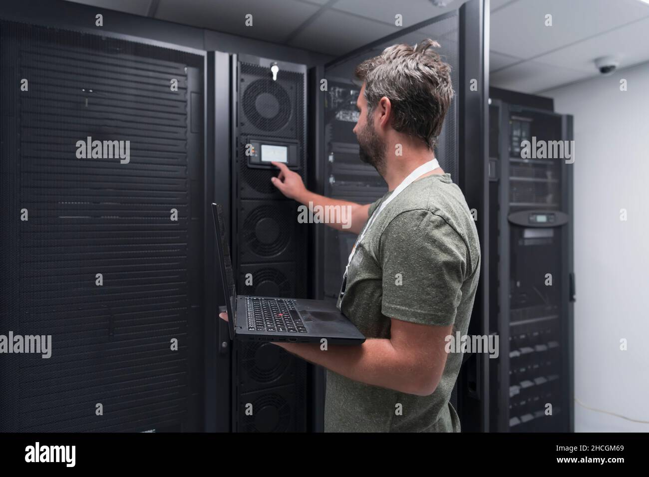 Data Center Engineer Using Laptop Computer Server Room Specialist ...