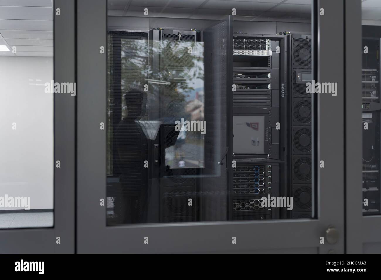 Software Engineer Working on a Laptop Computer in a Modern Server room ...