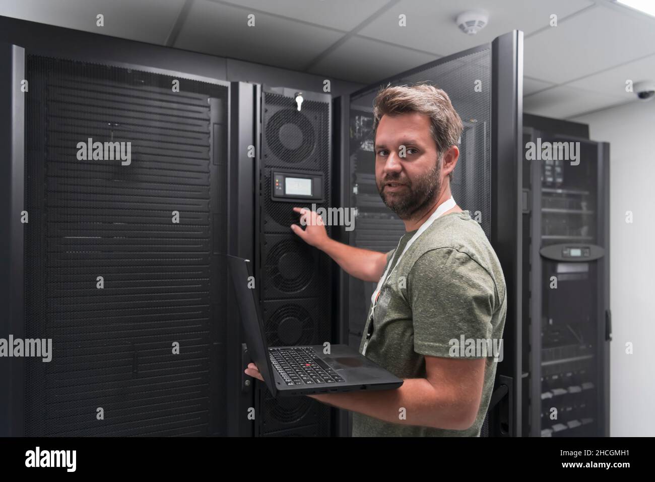 Data Center Engineer Using Laptop Computer Server Room Specialist ...