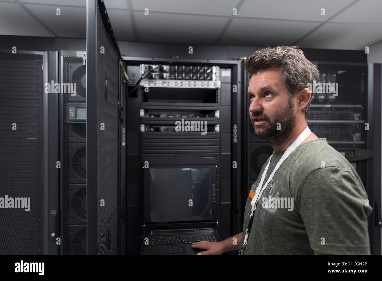 Data Center Engineer Usaing Keyboard on a Supercomputer Server Room ...