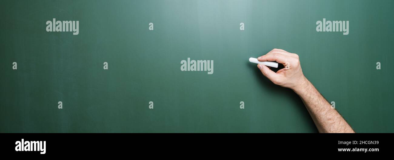 hand starts writing with chalk on a clean blackboard Stock Photo - Alamy