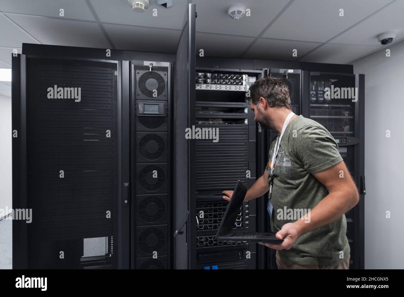 Data Center Engineer Usaing Keyboard on a Supercomputer Server Room ...