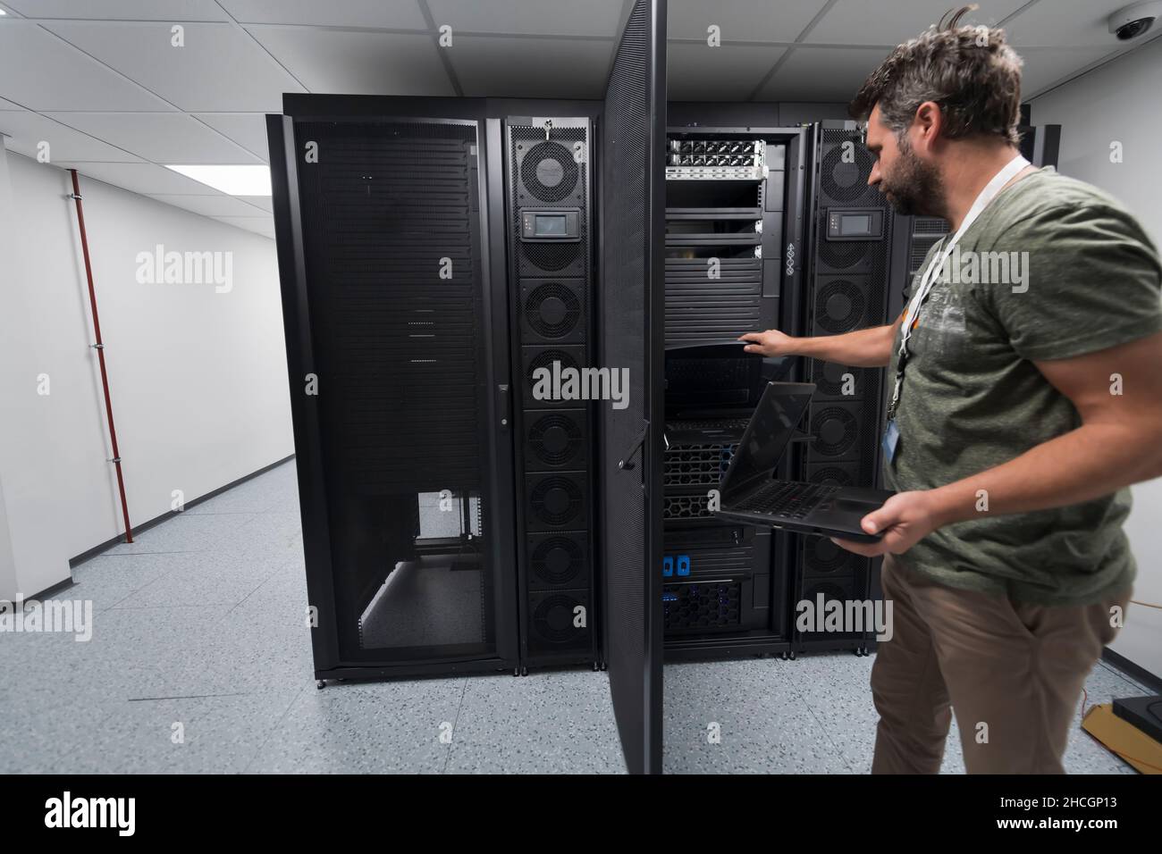 Data Center Engineer Usaing Keyboard on a Supercomputer Server Room ...