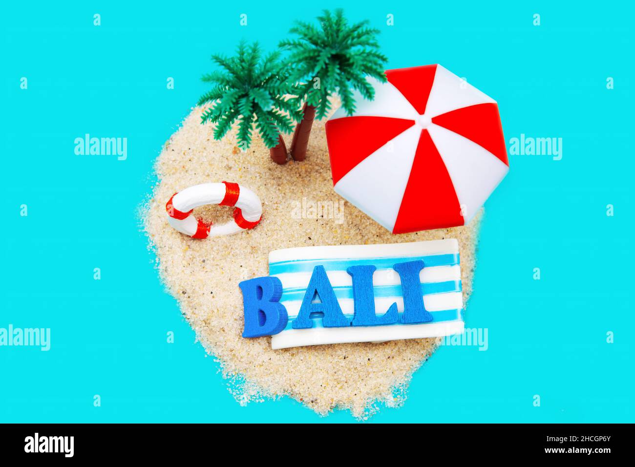 Aerial view of a sandy beach club composition made from sand, toy palm ...