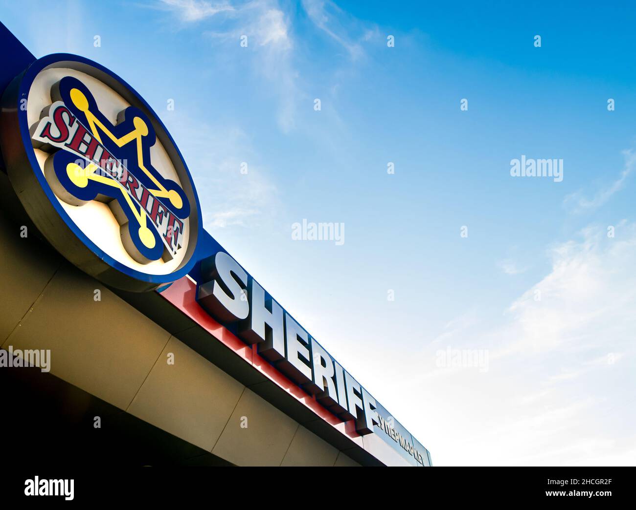 Sheriff supermarket logo on display with blue sky in the background ...
