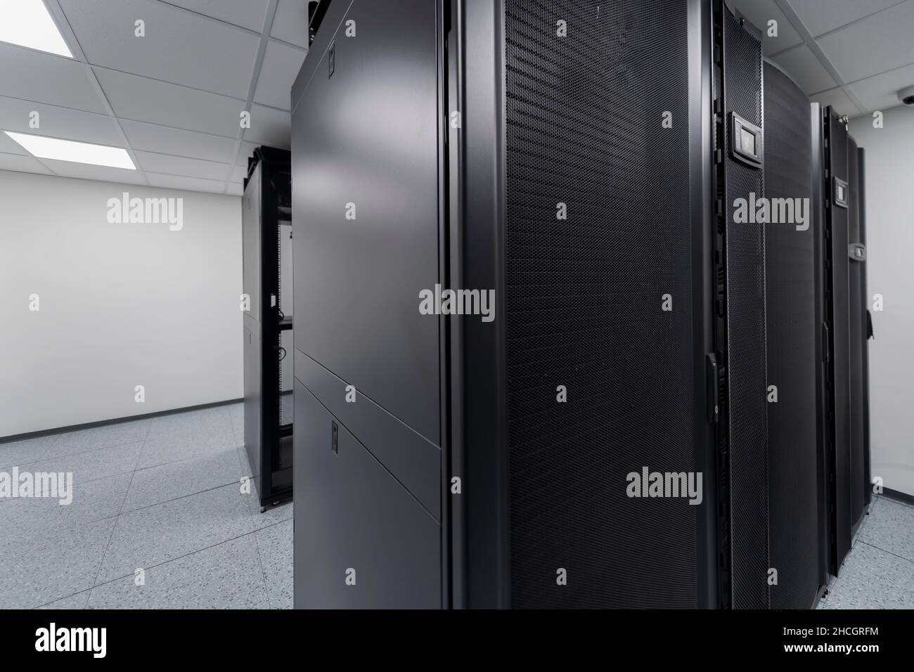Data Center With Multiple Rows of Fully Operational Server Racks. Modern Telecommunications ...