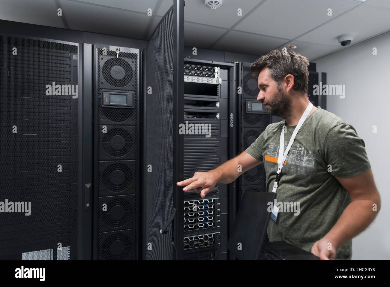 Data Center Engineer Usaing Keyboard on a Supercomputer Server Room ...